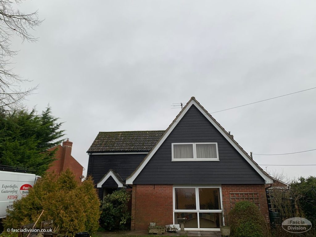 Midnight Black Hardieplank cladding, white fascias and soffits ...